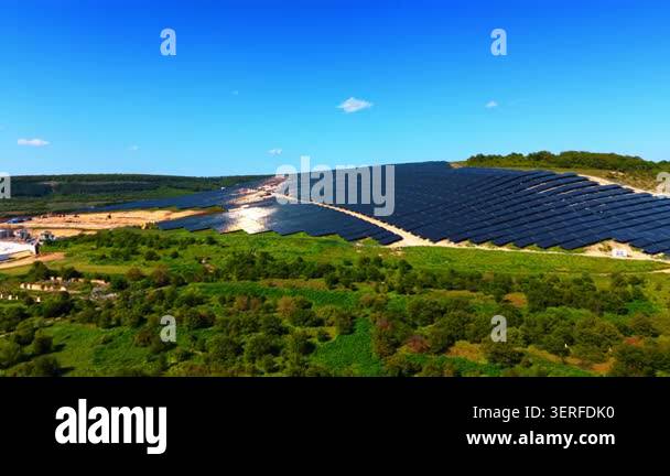 Hillside solar power station under construction surrounded by green ...