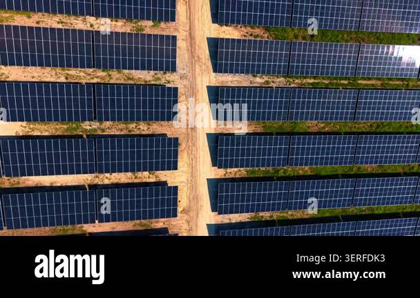Top down view of solar panel rows separated by dirt pathways ...