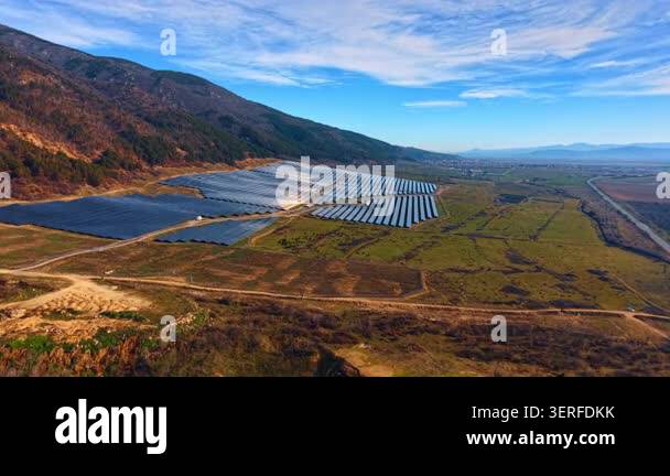 Mountain valley solar farm surrounded by green pastures. Aerial wide ...