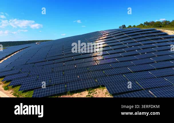 Expansive solar panel installation covering a hilltop on a clear day ...
