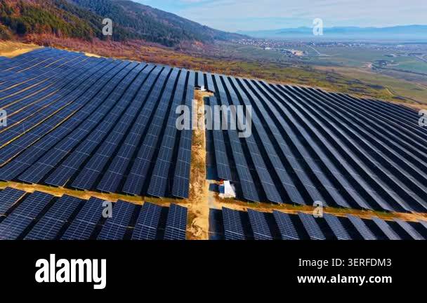 Parallel solar panel rows with central maintenance path. Drone view of ...