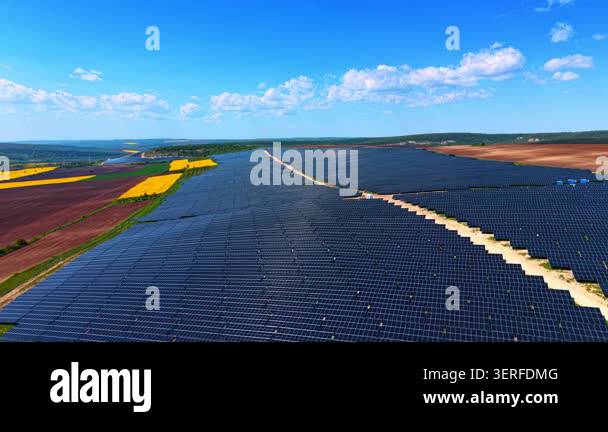 Expansive solar panel rows stretching across rolling farmland under ...