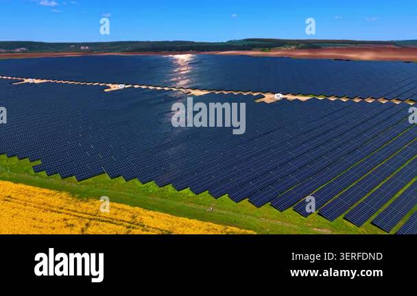 Diagonal rows of solar panels with sun glare on photovoltaic surface ...