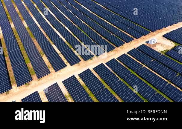 Overhead view of solar panel grid with maintenance road intersection ...