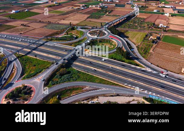 Aerial view of cloverleaf interchange surrounded by farmland, Spain ...