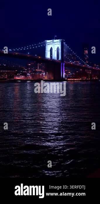 Vertical framing of Brooklyn Bridge tower at night, New York. Close up ...