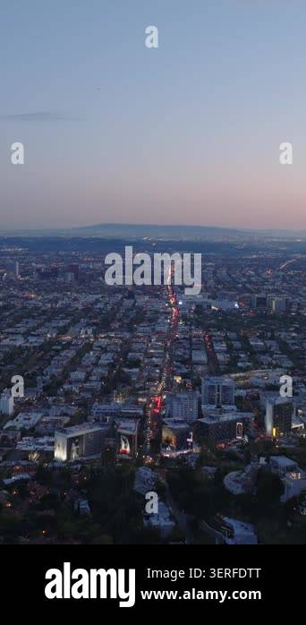 Fly hight above metropolis. Panoramic footage of large city at twilight ...