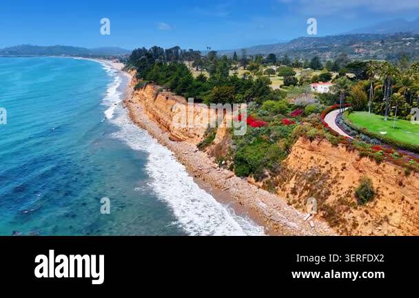 View on the gorgeous blooming garden located on the rocky shore. Drone ...