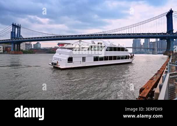 New York, USA, 8 May 2026: White cruise vessel docked beneath Manhattan ...
