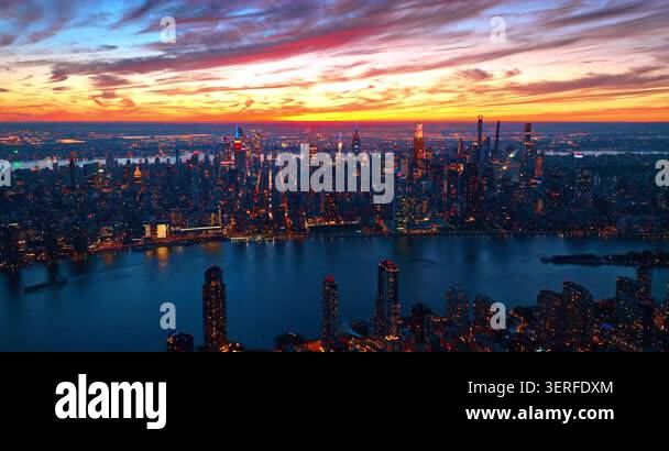 Approaching the river crossing the cityscape at sunset. Aerial ...