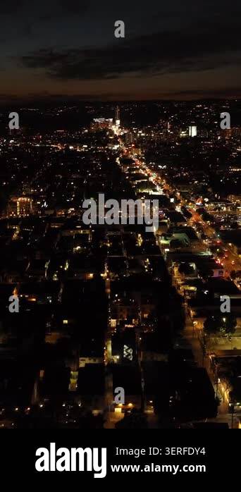 Aerial panoramic footage of night city. Fly above urban borough ...