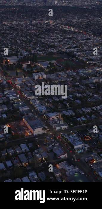Aerial panoramic shot of metropolis in evening. Vast residential urban ...