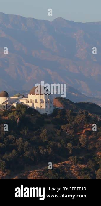 Griffith Observatory perched on a hill with San Gabriel Mountains in ...