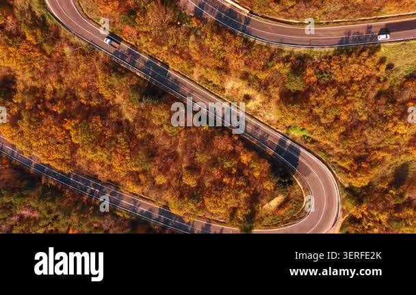 Overhead drone perspective of curved highway in colorful autumn ...