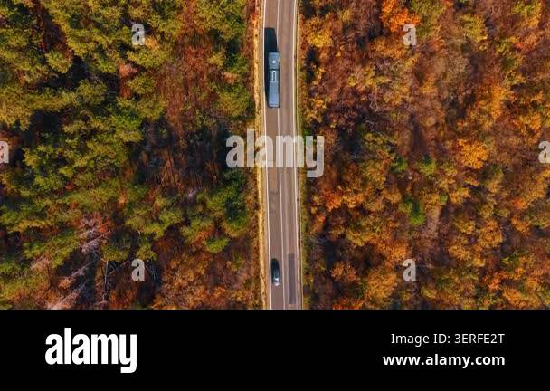 Top down view of truck on straight forest road in autumn. Vehicle ...