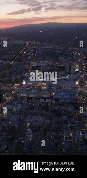 Aerial panoramic footage of metropolis against colourful sunset sky ...