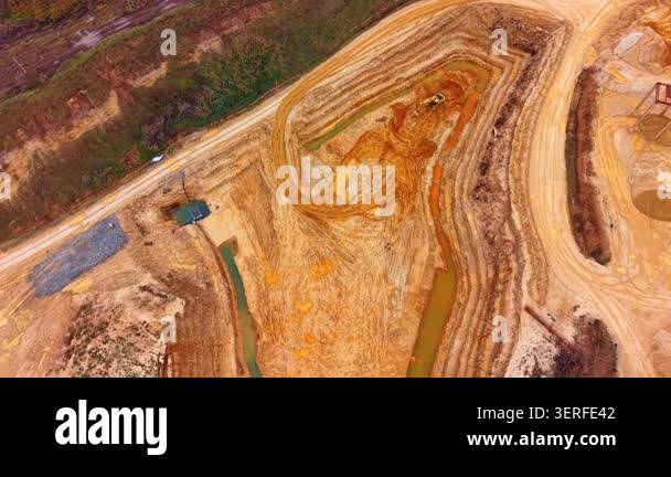 Aerial view of open pit sand quarry with heavy equipment. Overhead ...