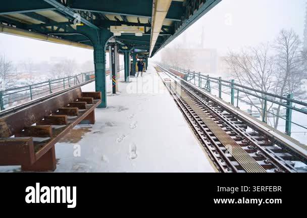 New York, USA, 12 January 2026: Snowy elevated subway station platform ...