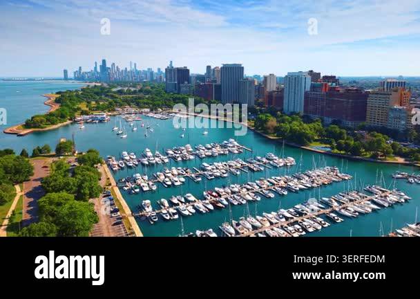 Lots of vessels at the berths in the harbor. Lush greenery surround ...