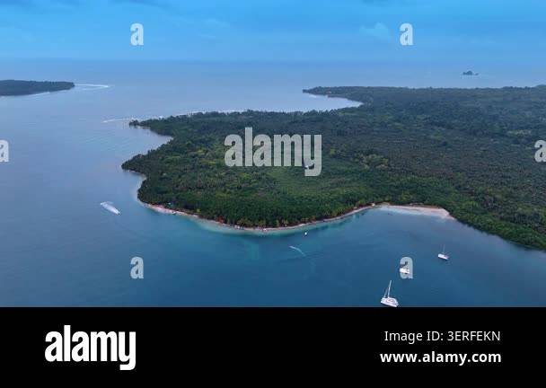 Forested headland surrounded by turquoise sea, Bocas del Toro, Panama ...