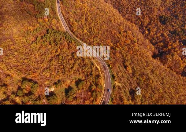 Golden hour light over curving mountain road in autumn. Warm sunset ...