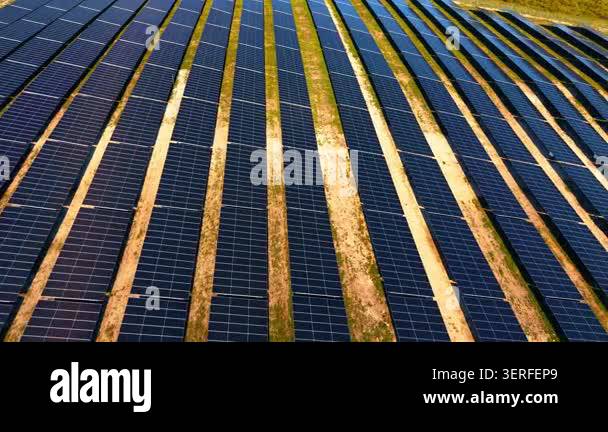 Numerous photovoltaic cells in rows turned to the bright hot sun. Solar ...