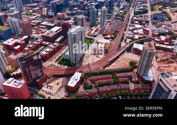View on the railways with moving trains crossing the cityscape of a ...