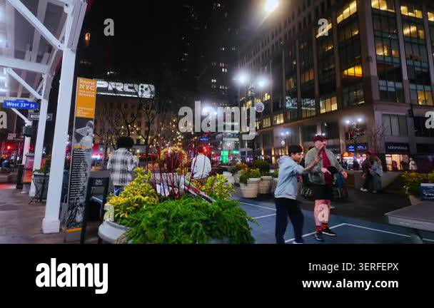 New York, USA, 25 December 2025: Evening pedestrian plaza at West 33rd ...