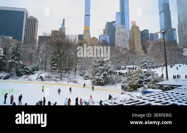 New York, USA, 25 December 2025: Ice skaters at Wollman Rink with snowy ...