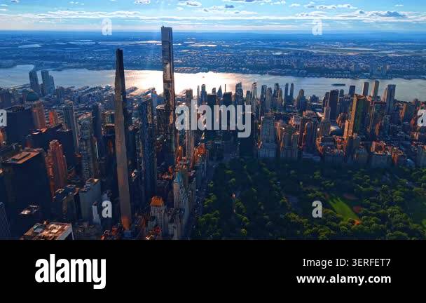 Sunset over Central Park and urban towers, New York. Wide panoramic ...