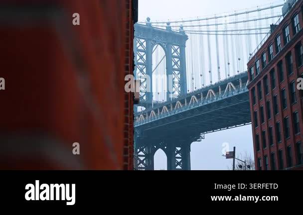 New York, USA, 25 December 2025: Manhattan Bridge tower framed by brick ...