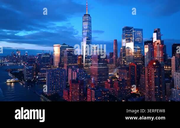 One World Trade Center with illuminated green spire at dusk in NYC ...