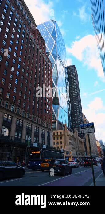 New York, USA, 5 November 2025: Triangular glass tower and brick facade ...