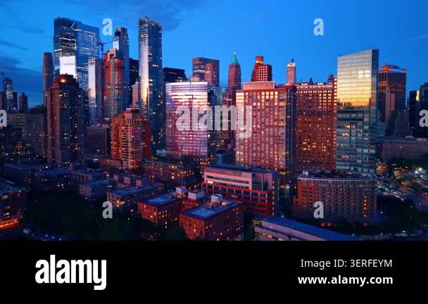 Golden sunset reflections on Lower Manhattan skyscrapers at blue hour ...