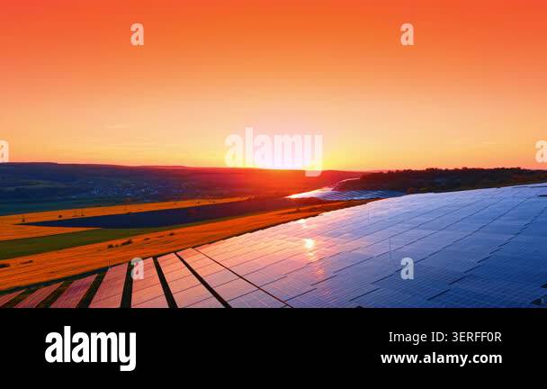Twilight sky above solar panel arrays and golden wheat fields. Gradient ...