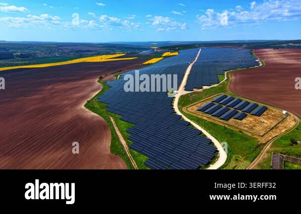 Solar panel arrays stretching between plowed farmland and rapeseed ...