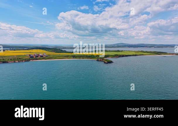 Green coastline with yellow fields and sandy cove near Burgas, Bulgaria ...