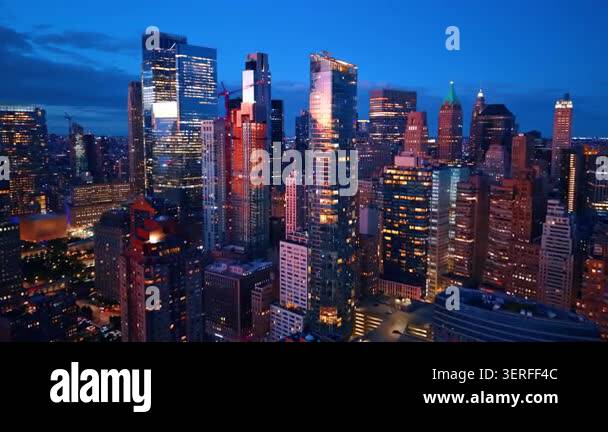 Stunning glossy high-rises reflecting the city lights. Drone flight ...