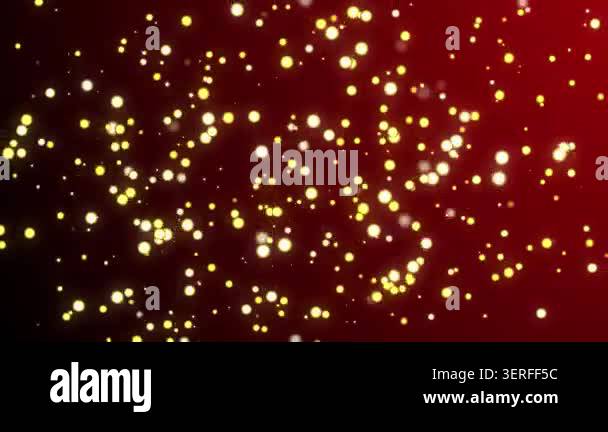 Sparkling golden particles on a rich red background for holiday ...