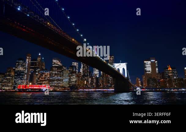 Brooklyn Bridge spanning the East River at night, New York City. Low ...