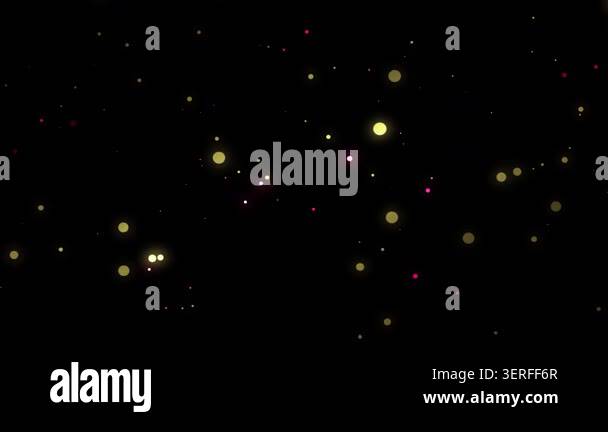 Sparkling yellow and pink bokeh particles on dark background for ...