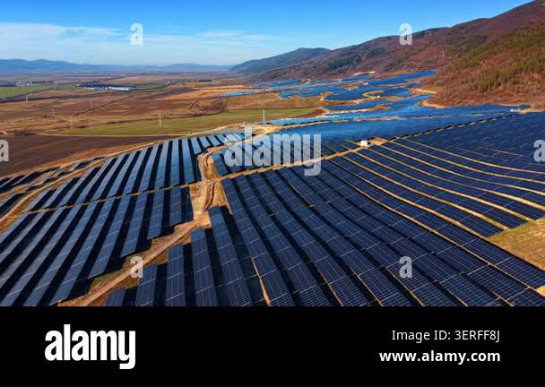 Late afternoon light on solar farm spreading across mountain valley ...