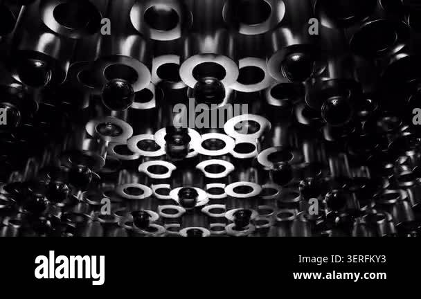 Dense black and silver circular forms hang above in a dark abstract ...