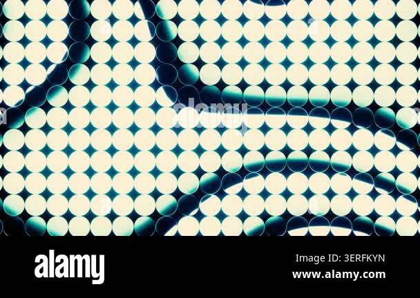 Close view of a bright matrix of circular light spots crossed by dark ...