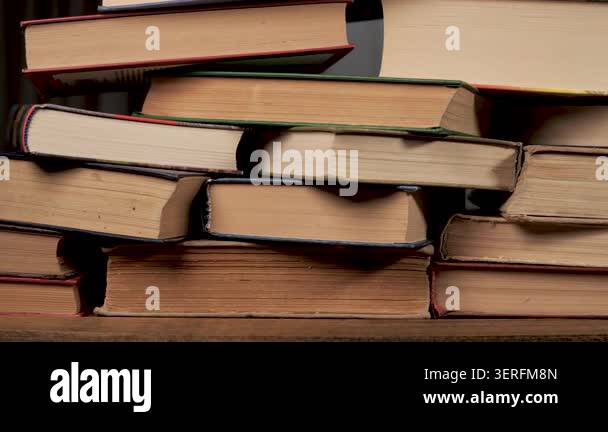 Stack of old hardcover books on wooden table education concept, close ...