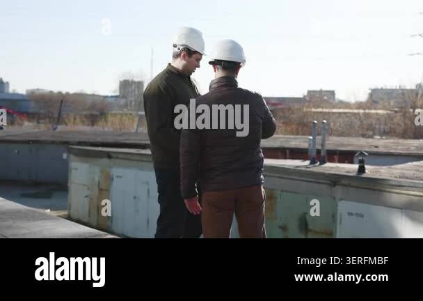 Two Workers Rooftop Handshake Inspection Site During Roof Handover ...