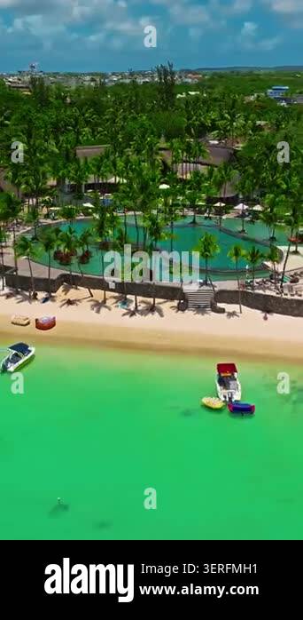 Aerial view of crystal water on the seashore, Mauritius with palm trees ...