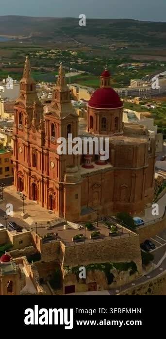 Aerial view of the Mellieha Church with red dome and the sea in the ...