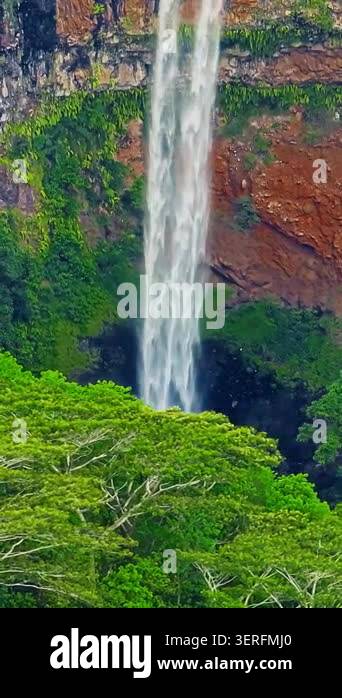 Aerial view of Chamarel Waterfall, plunging from verdant cliff into ...