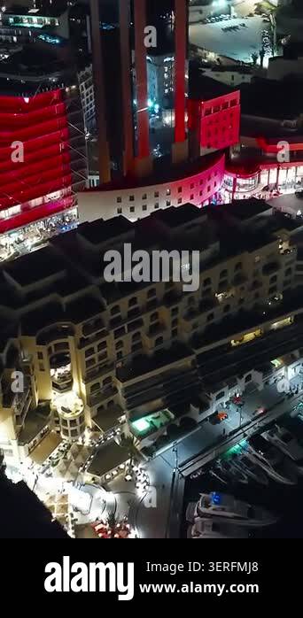 Aerial of night view of Paceville, St. Julians city with modern towers ...